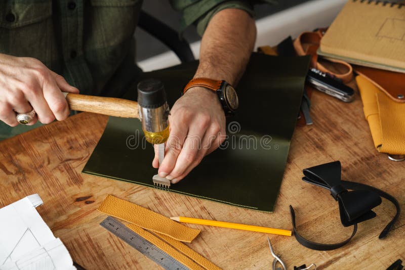 White Craftsman Using Hummer while Working with Leather Stock Image ...