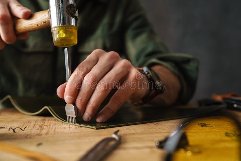 White Craftsman Using Hummer while Working with Leather Stock Photo ...