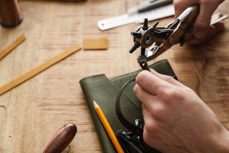White Craftsman Using Tool while Working with Leather Stock Photo ...