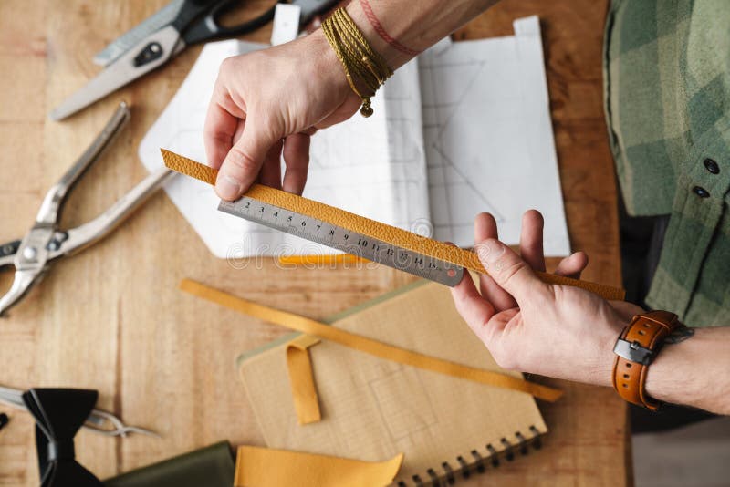 Craftsman Drawing while Working with Leather in Workshop Stock Image ...