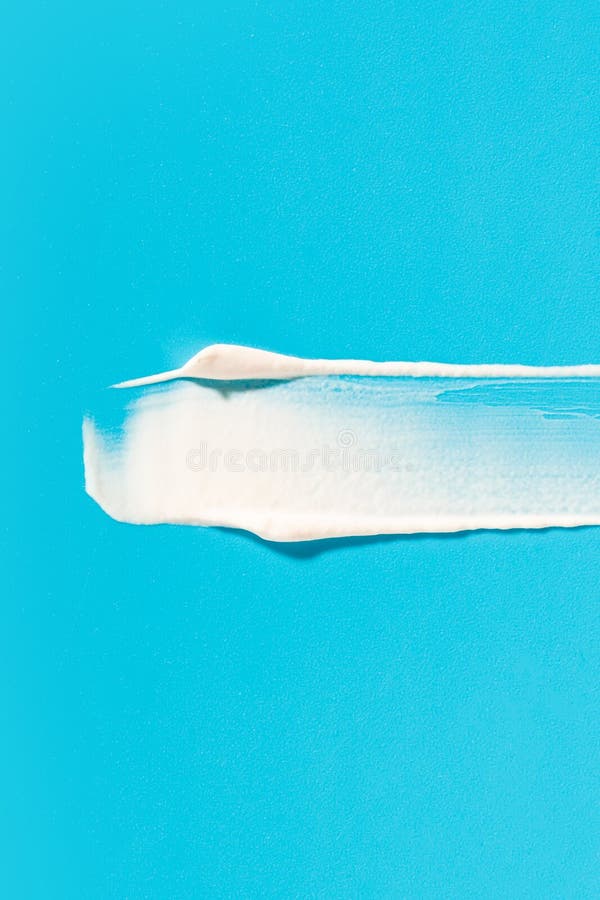White Cream Smear on a Blue Background. Stock Photo - Image of balm ...