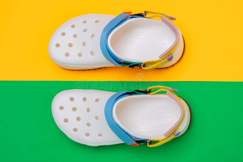 White Crocs Sandals on Yellow and Green Background. Top View Stock ...