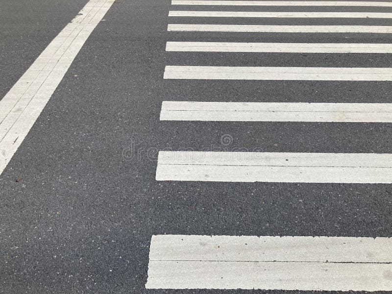White Crosswalk Sign on Grey Asphalt Road with a White Straight Line ...