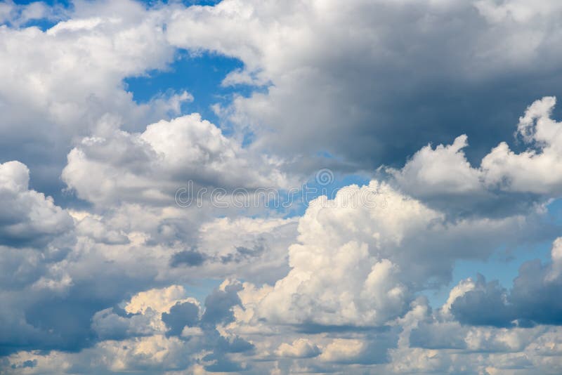 White Cumulus Clouds and Grey Storm Clouds on Blue Sky Stock Image ...