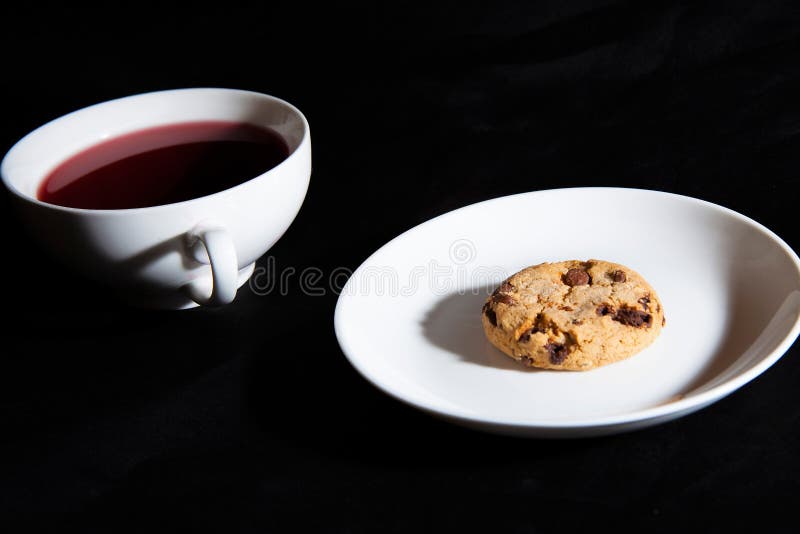 White Cup of Berry Tea and Cookie on the White Plate. Black Background ...