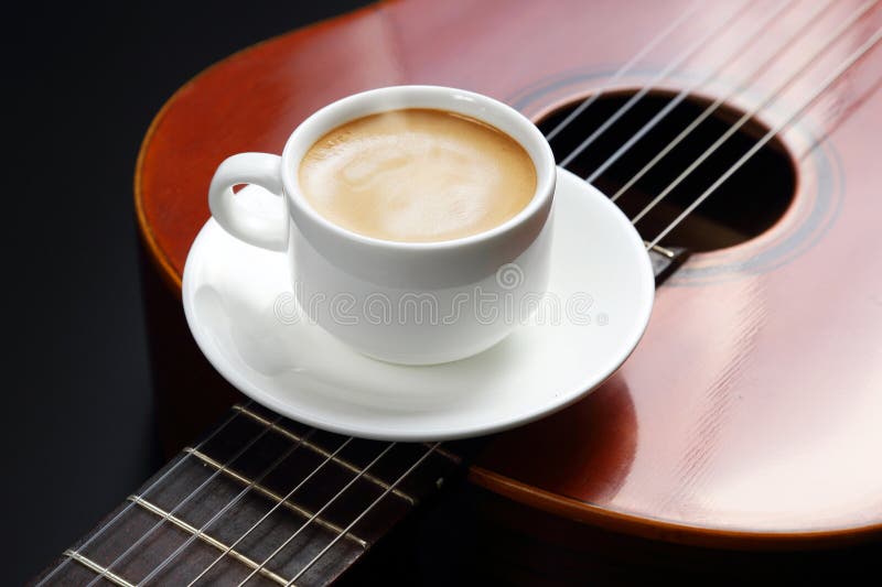 White Cup with Black Coffee Lying on the Acoustic Guitar Stock Image ...