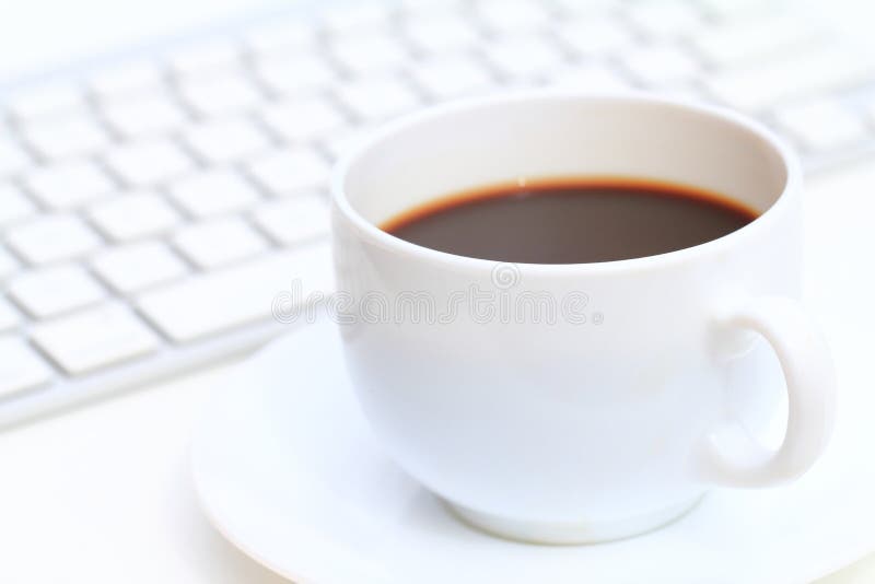 White Cup of Coffee in Front of Computer Keyboard Stock Image - Image ...
