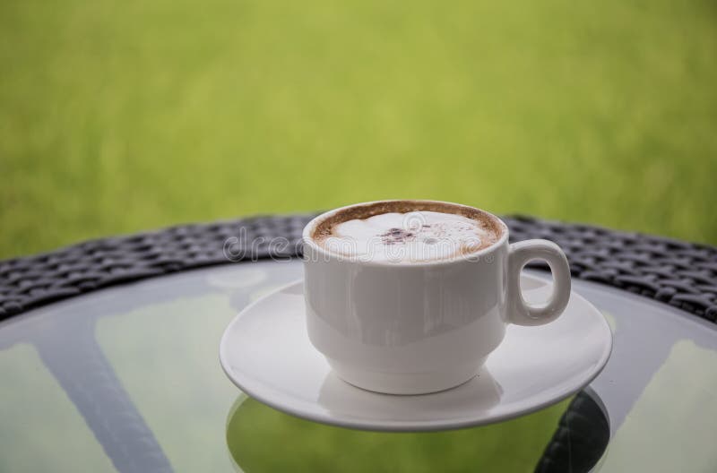 A White Cup of Coffee on the Table with a Backdrop of Rice Fields Stock ...