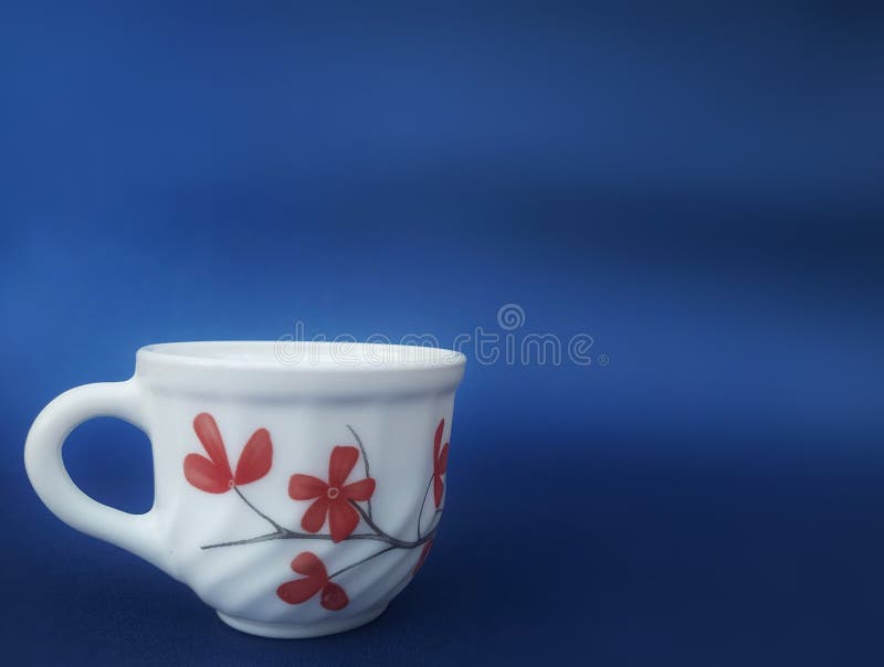 White Cup with Flower Pattern in Blue Background Stock Photo - Image of ...