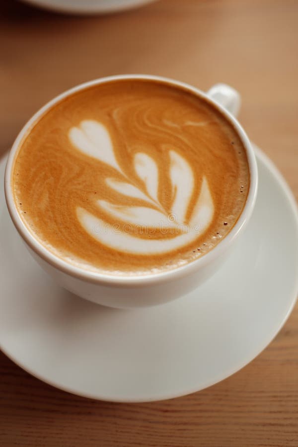 White Cup of Fragrant Cappuccino Stand on a Wooden Table. Coffee with ...