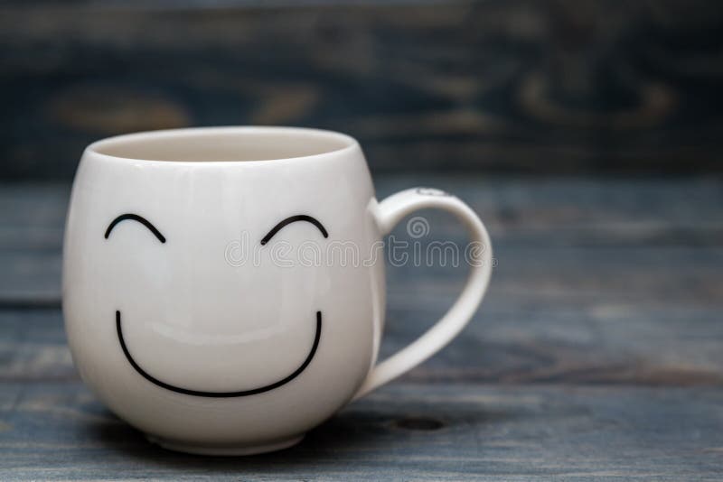 White Cup with Smiley Face on Blue Wooden Table Stock Image - Image of ...