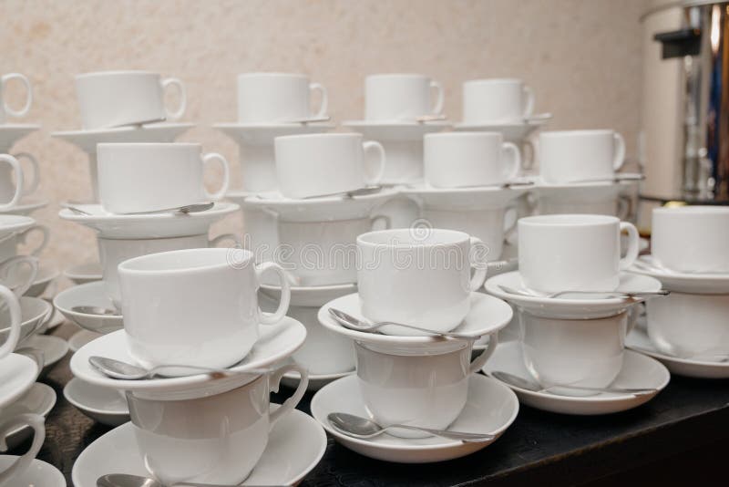 White Cups for Tea Piled on Table with Plates for Coffee-break Stock ...