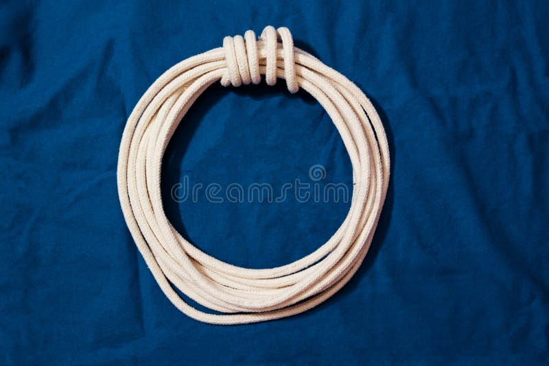 White Curled Up Rope on Blue Fabric Stock Photo - Image of line, frame ...
