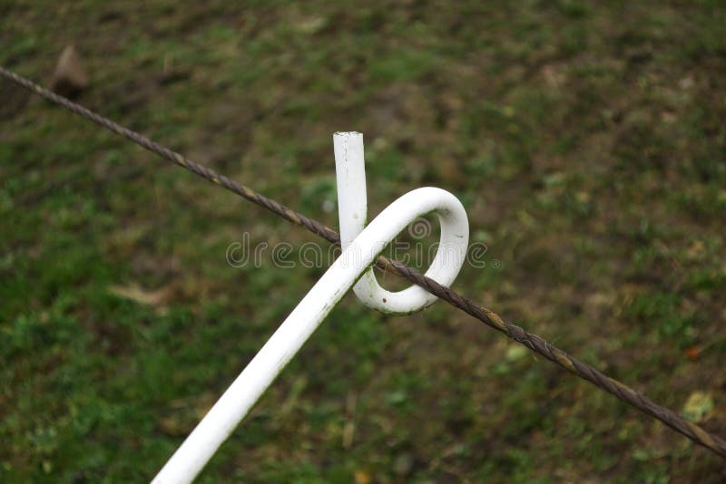 White Curled Wire Guide or Rope Guide in a Meadow Stock Photo - Image ...