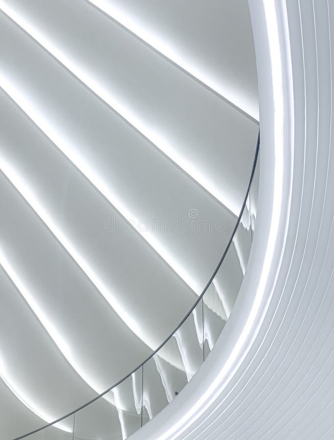 A White, Curved Ceiling with a Metal Railing and Lighting Stock Photo ...