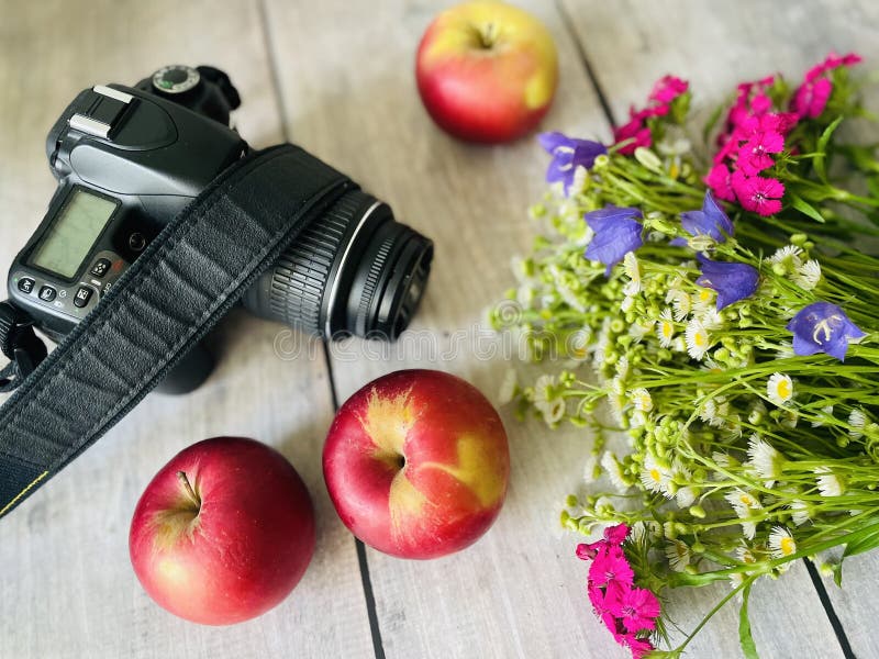 White Daisies, Blue Bluebells, Red Apples on the Table in Summer Stock ...