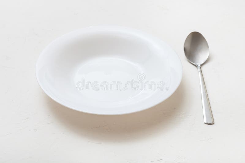 White Deep Plate and Spoon on Plaster Stock Image - Image of plaster ...