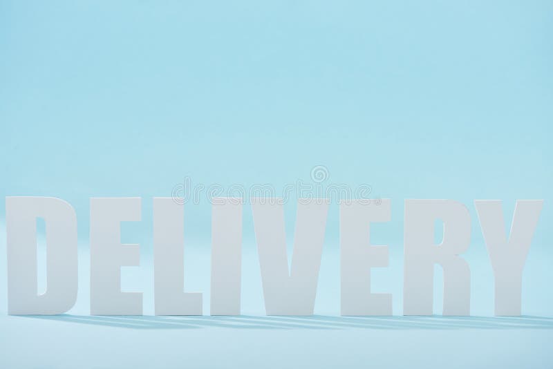 White Delivery Text with Shadows on Blue Background. Stock Photo ...