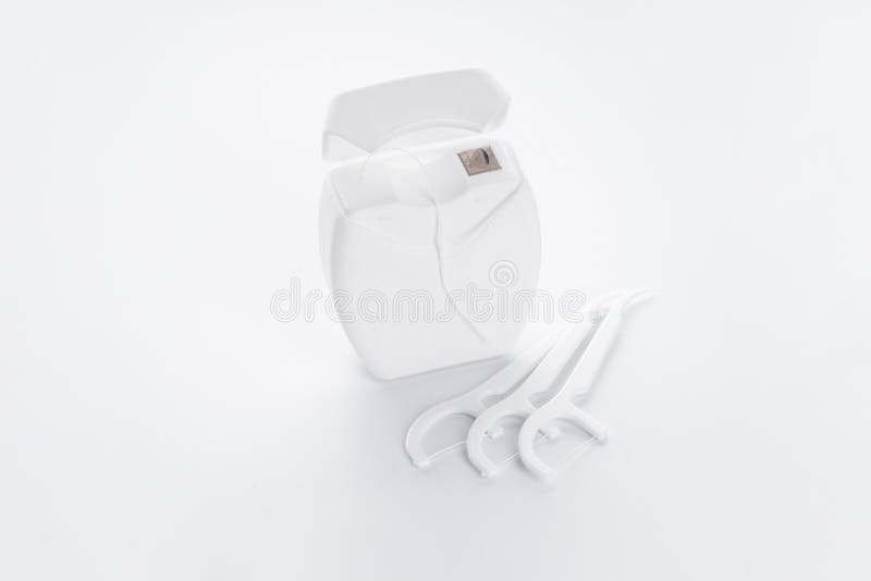 White Dental Floss Packaging with White Toothpicks and Floss on a White ... White Dental Floss Packaging with White Toothpicks and Floss on a White ...