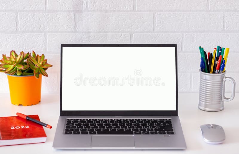 White Desktop and Brick Wall with Organizer, Laptop Computer and Mouse ...