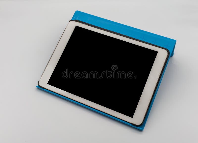 White Digital Tablet on Blue Plastic Tablet Stand Isolated on White ...