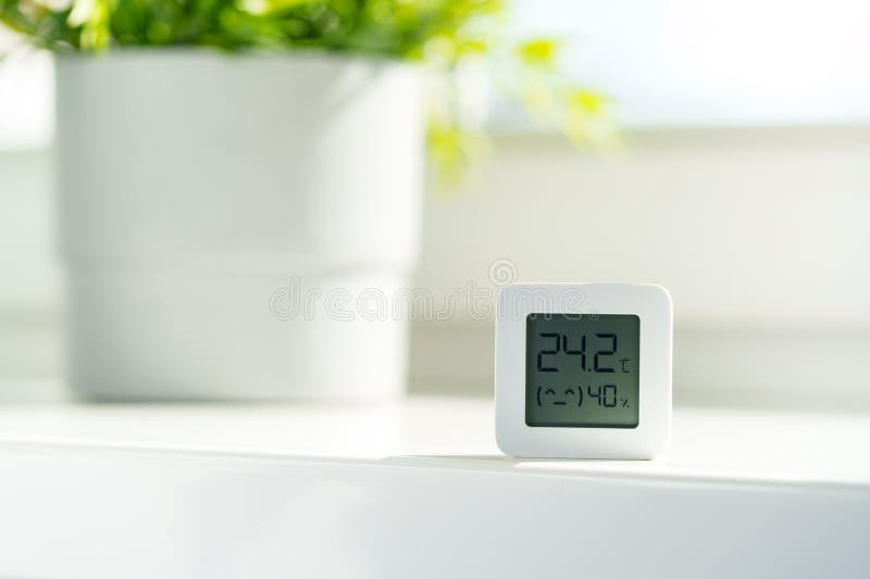 White Digital Thermometer Displaying Room Temperature and Humidity ...