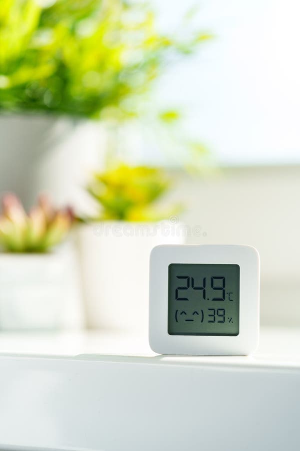 White Digital Thermometer Displaying Room Temperature and Humidity ...