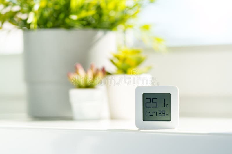White Digital Thermometer Displaying Room Temperature and Humidity ...