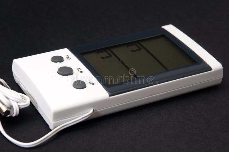 White Digital Thermometer with a Sensor on a Black Background Stock ...