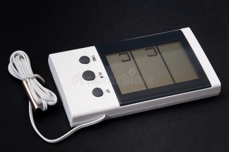 White Digital Thermometer with a Sensor on a Black Background Stock ...