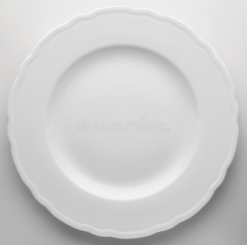 White Dinner Flat Plate with Wavy Edge Seen from Above Stock Photo ...