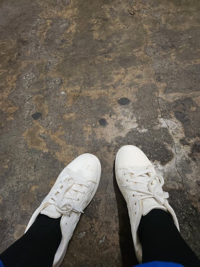 White Dirty Sneaker with Blue Socks on Concrete Ground Ready for ...