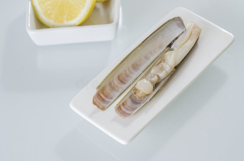 White Dish of Grilled Razor Clams with Lemon Stock Photo - Image of ...