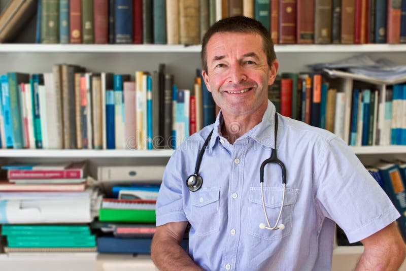 White Doctor in Front of Books Stock Photo - Image of friendly, healthy ...