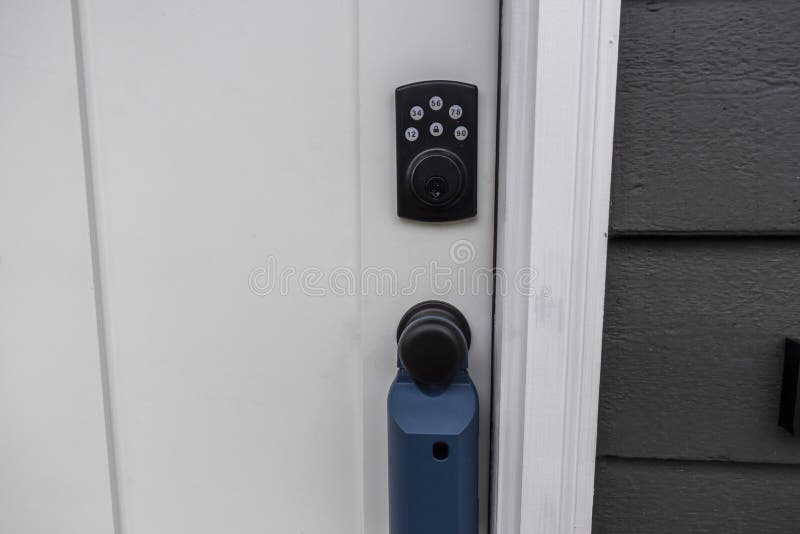 View of a White Door with Keypad Entry and a Real Estate Lock Box ...