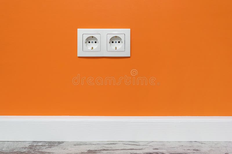 White Double Outlet on Orange Wall Stock Photo - Image of safety ...