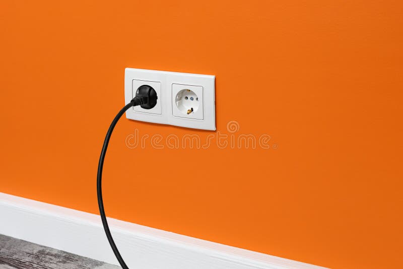 White Double Outlet on Orange Wall Stock Photo - Image of flooring ...