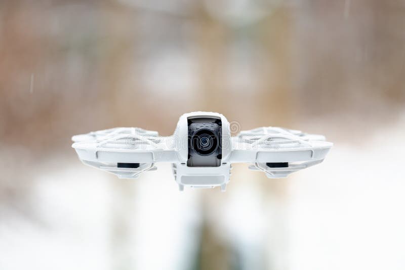 A White Drone with a Camera on it is Flying in the Air Stock Photo ...