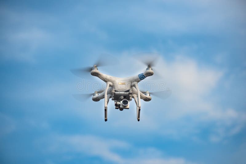 White Drone with Camera Flying in Blue Sky. UAV Concept Stock Photo ...
