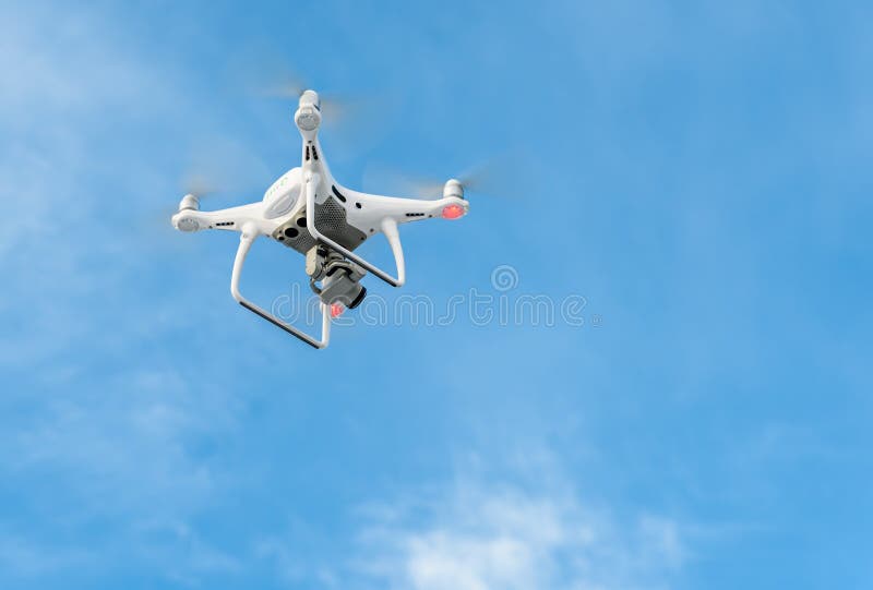 White Drone Flying in a Cloudy Blue Sky Stock Photo - Image of ...