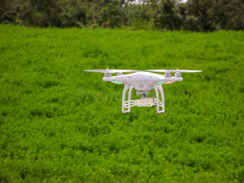 White Drone, Hovering Over Green Field Stock Photo - Image of field ...