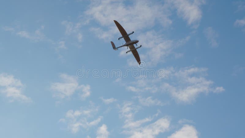 White Drone in the Shape of an Airplane Fly in the Clear Blue Sky. the ...
