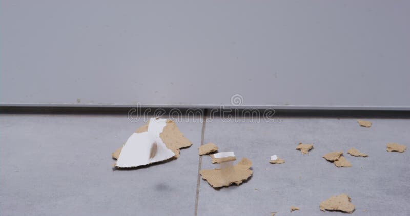 White Drywall Breaks into Small Pieces Falling on Floor Stock Footage ...