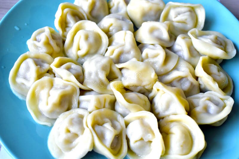 White Dumplings with Meat on a Blue Plate Stock Photo - Image of ...