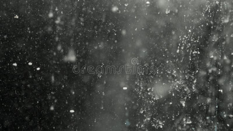 White Dust Particles Falling in Water on Black Background Stock Footage ...