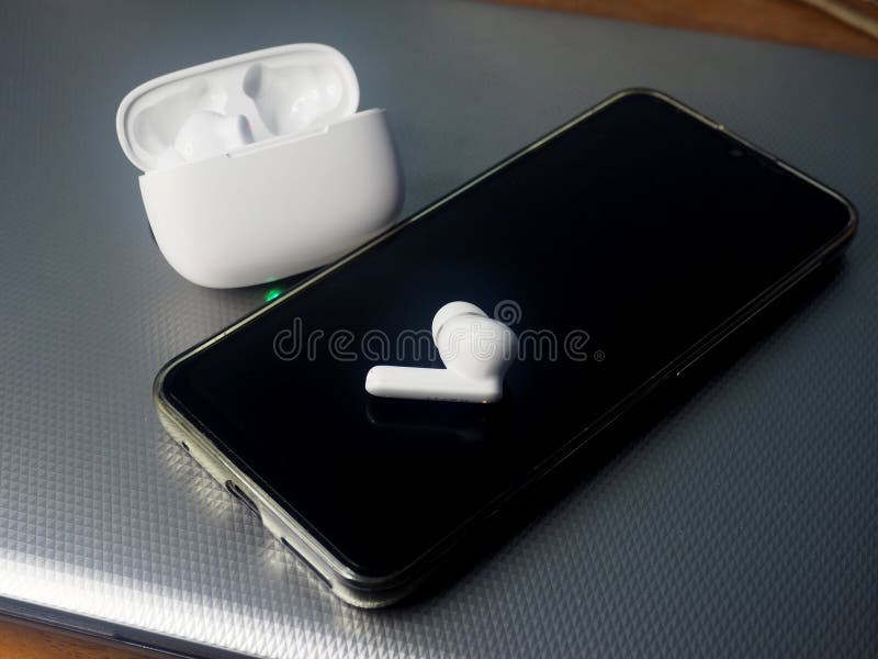 White Earbuds and Smart Phone Connect Together Stock Photo - Image of ...