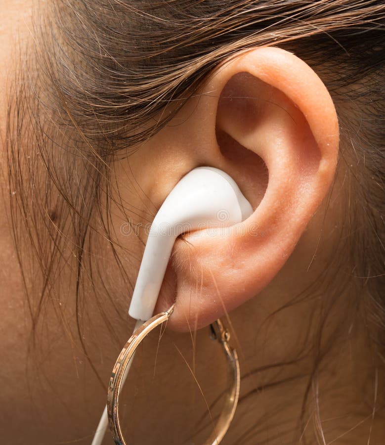 White earphone in the ear stock photo. Image of reduction - 108306330