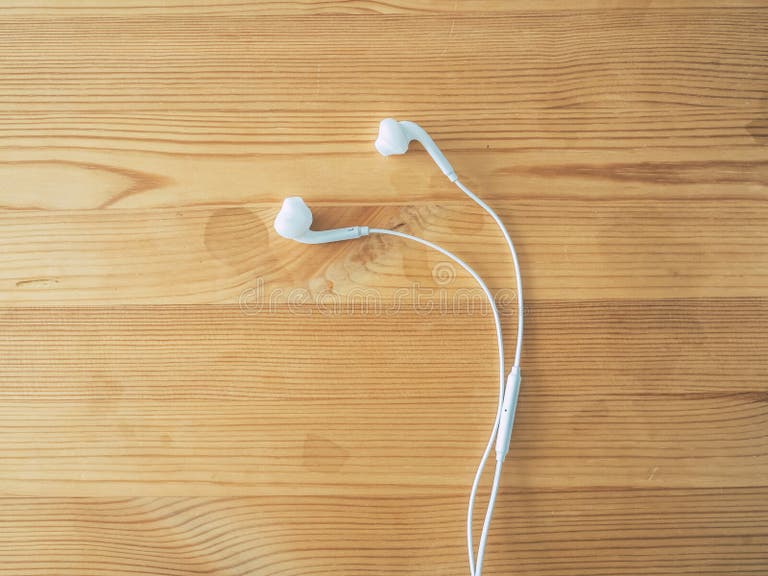 White earphone on table. stock image. Image of earphone - 87610131