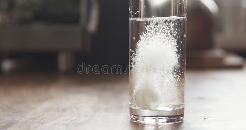 White Effervescent Tablet in Glass with Water on Table Stock Image ...