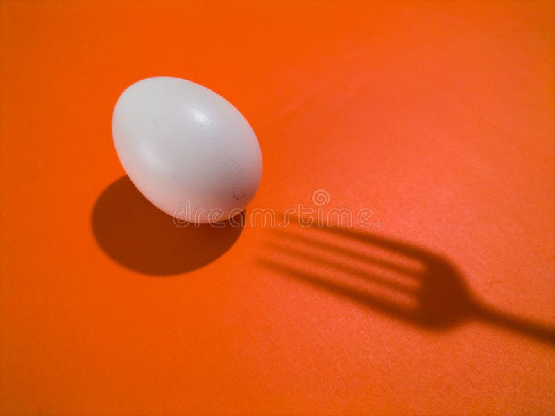 Egg and Shadow of a Fork on Orange Surface Stock Image - Image of ...